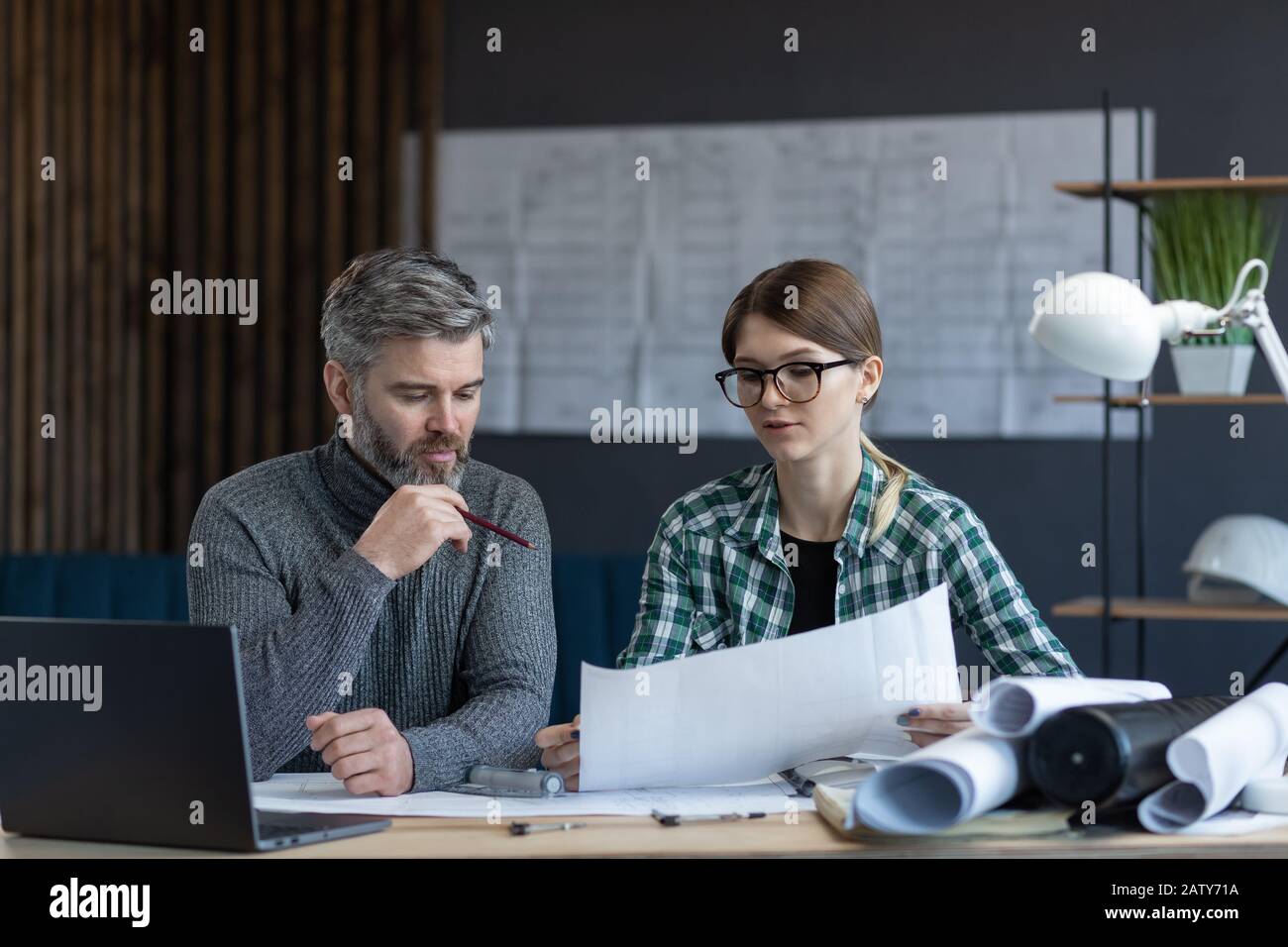 Interior designers team working in office with blueprints and architect ...