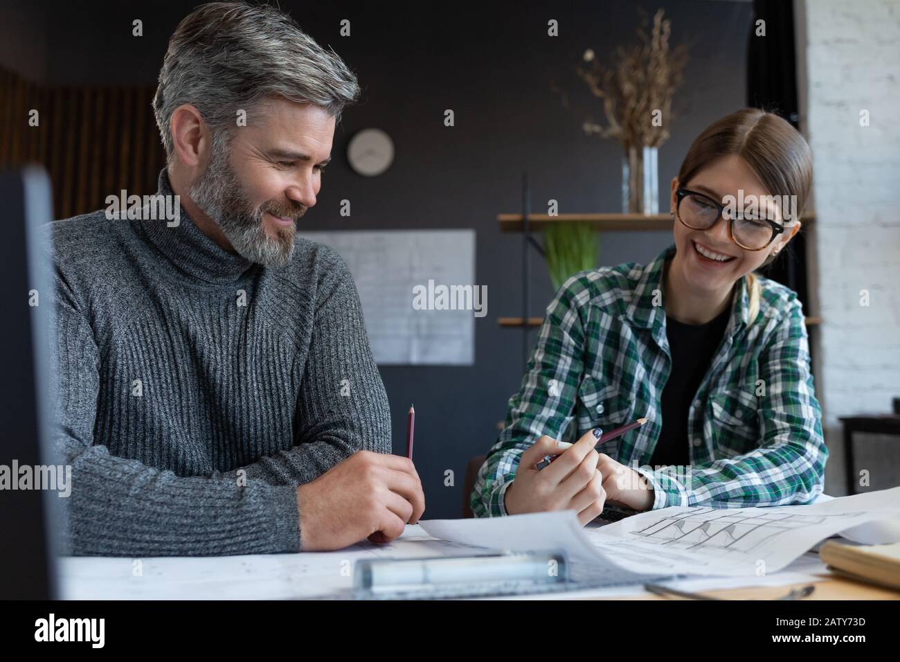 Interior designers team working in office with blueprints and architect ...