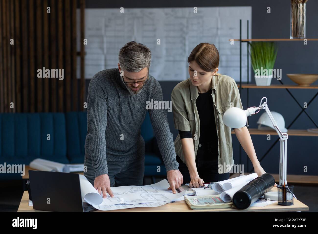 Engineer team working in office with blueprints and architect equipment ...