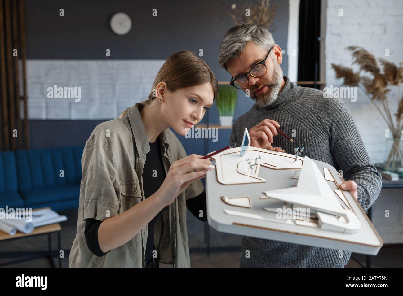 3d architects team working in office with building 3d model. Architects ...