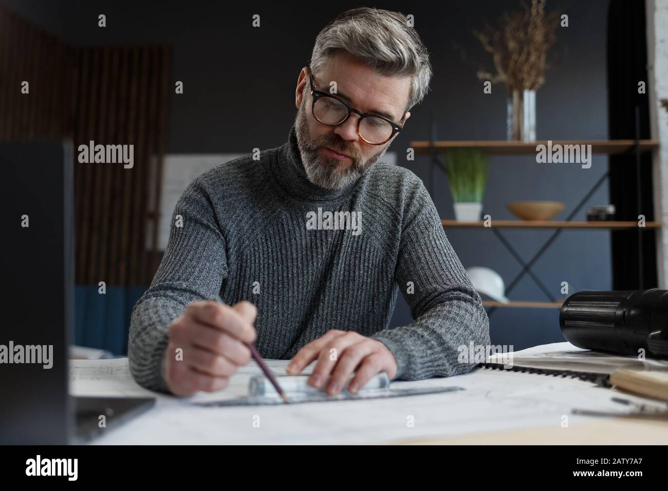 Interior designer working in office with blueprints.Engineer inspect ...