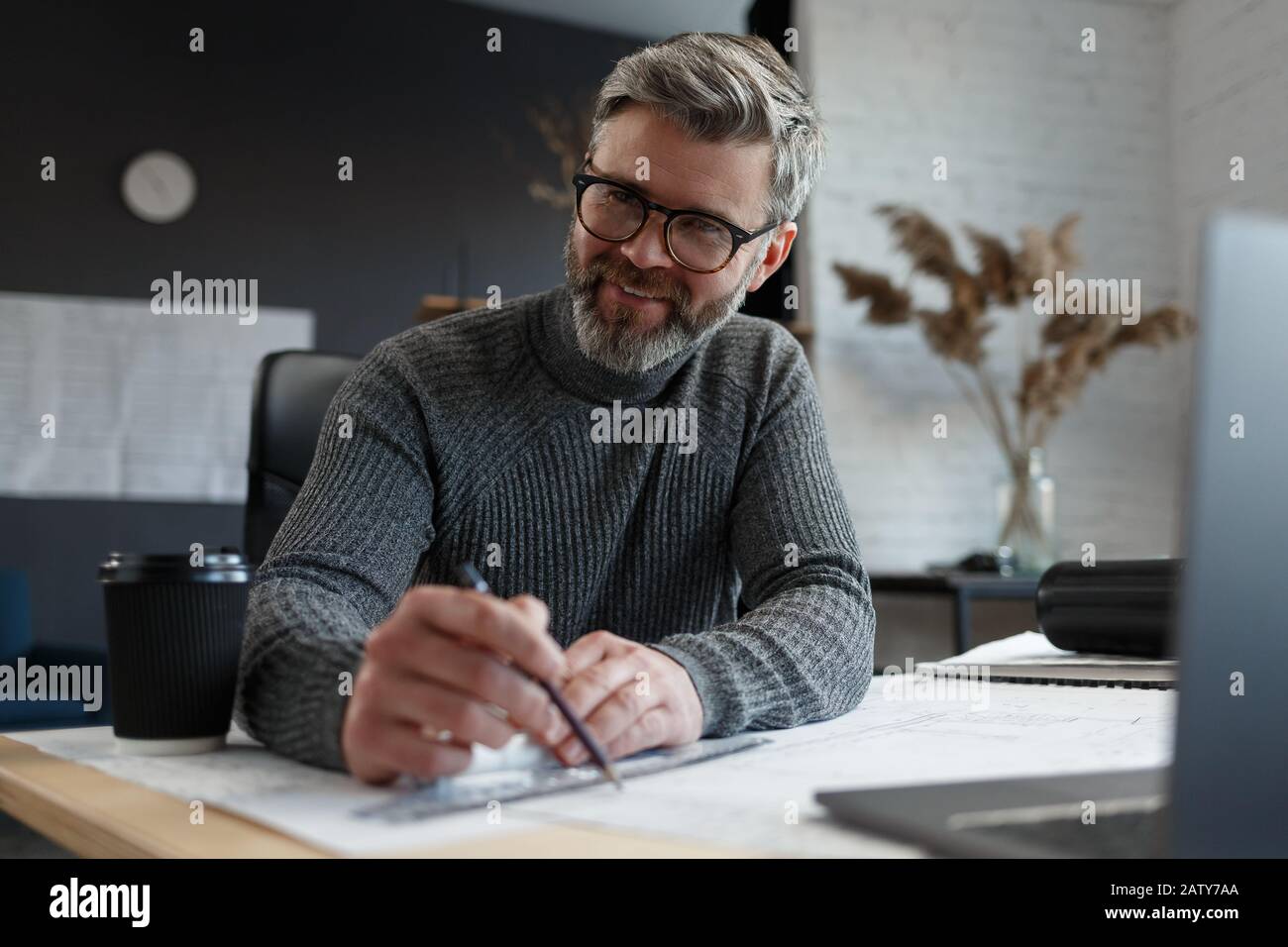 Interior designer working in office with blueprints.Engineer inspect ...