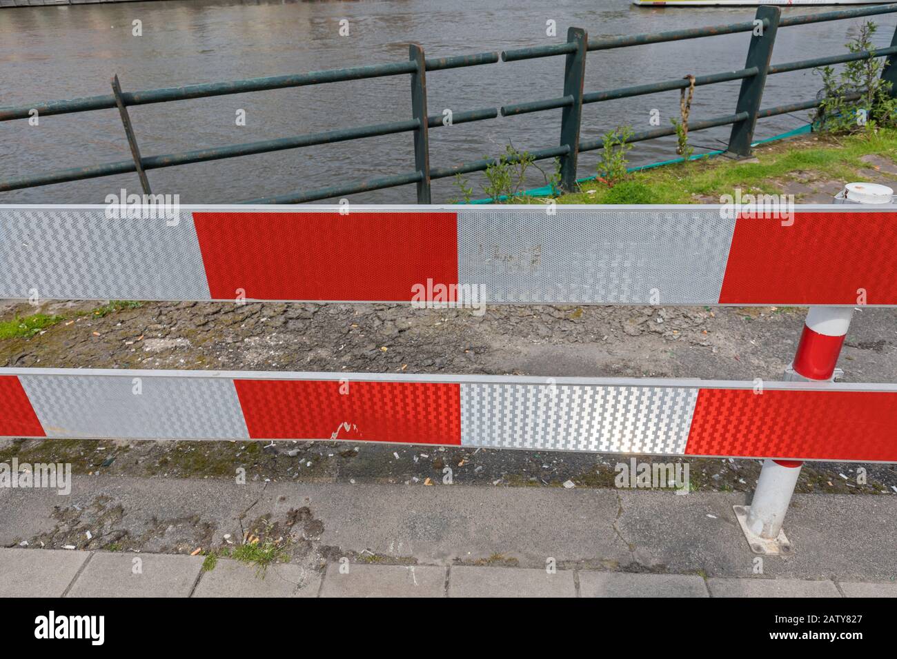 Red and White Reflective Barrier Near Canal Water Stock Photo - Alamy