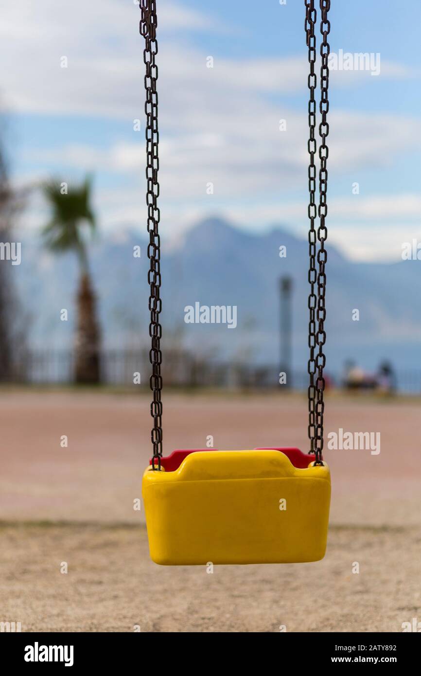 Blue and yellow swing set hi-res stock photography and images - Alamy