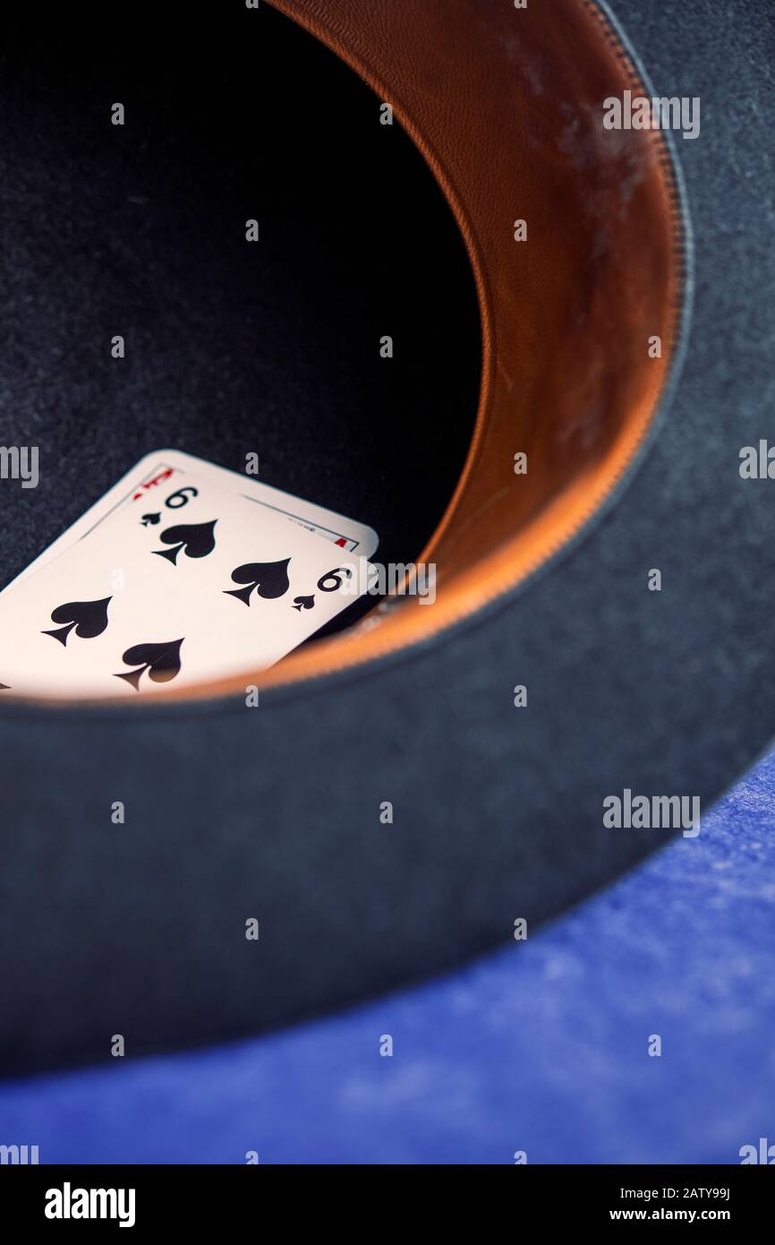 Playing cards inside a bowler hat Stock Photo - Alamy