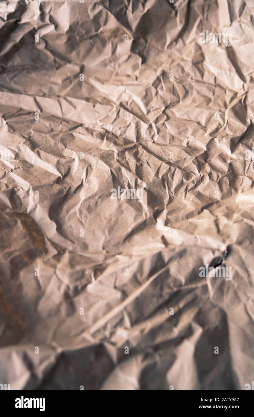 Crumpled and used piece of brown wrapping paper Stock Photo - Alamy