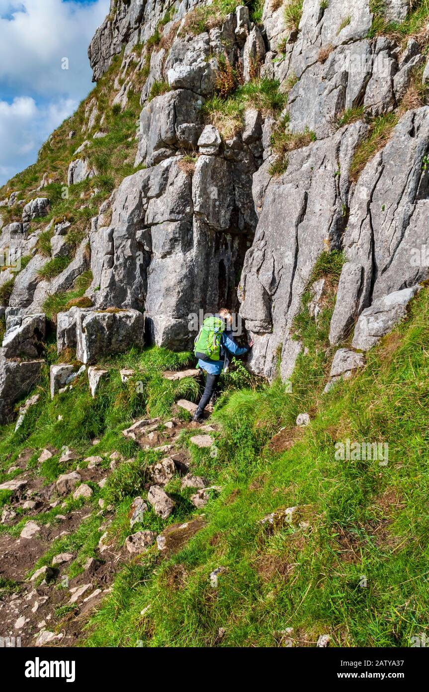 Dominika Wroblewska entering a small vertical cave entrance on ...