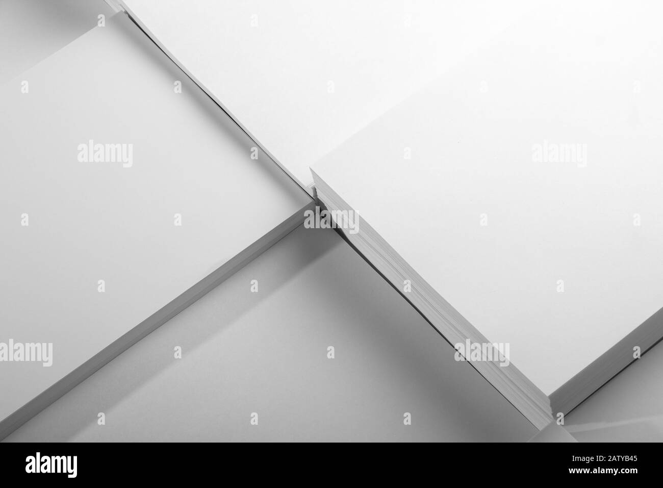 Several stacks of white paper on a white background Stock Photo - Alamy