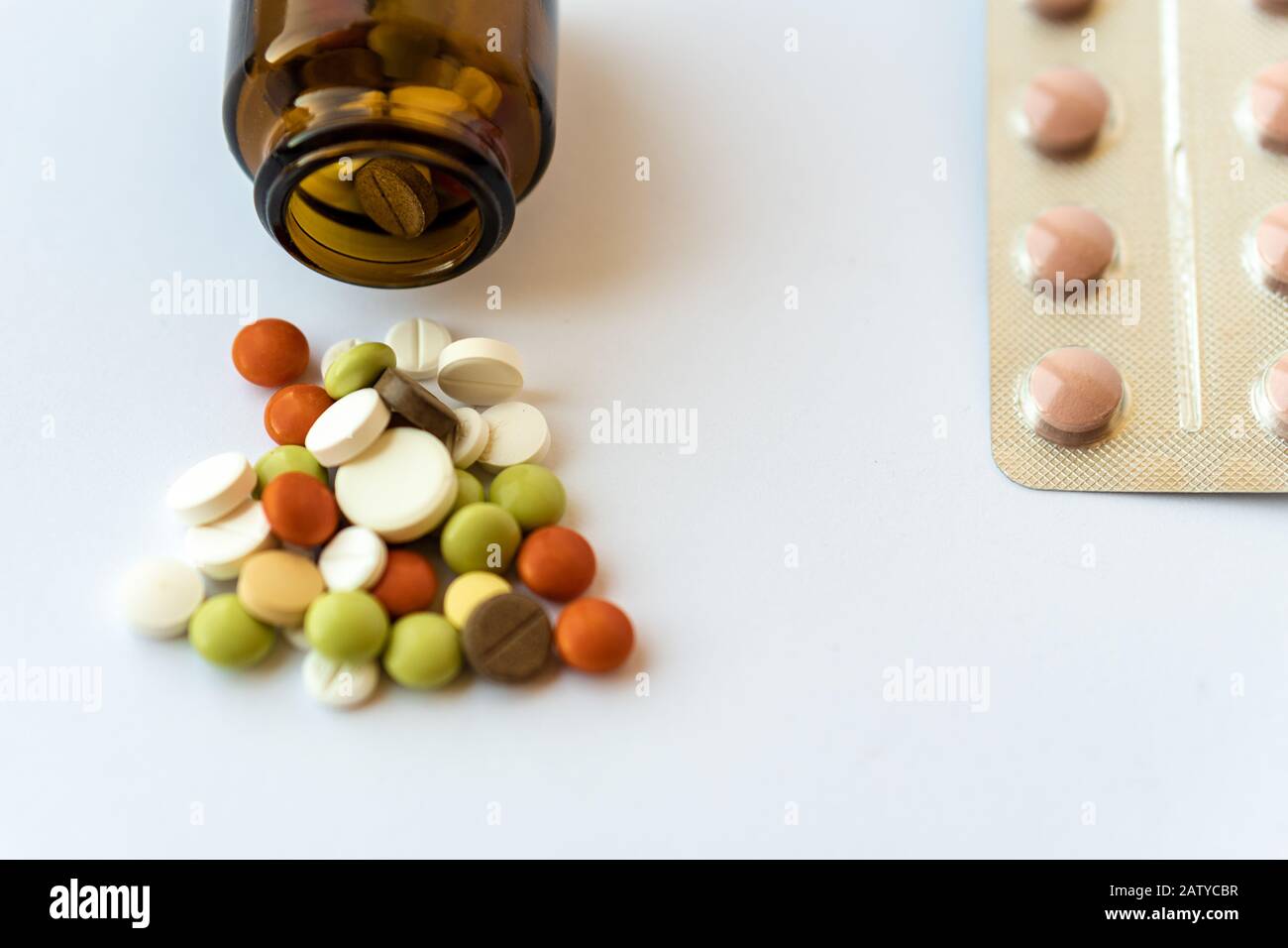 Medicine and pills. Multi-colored medicines on a white background close ...