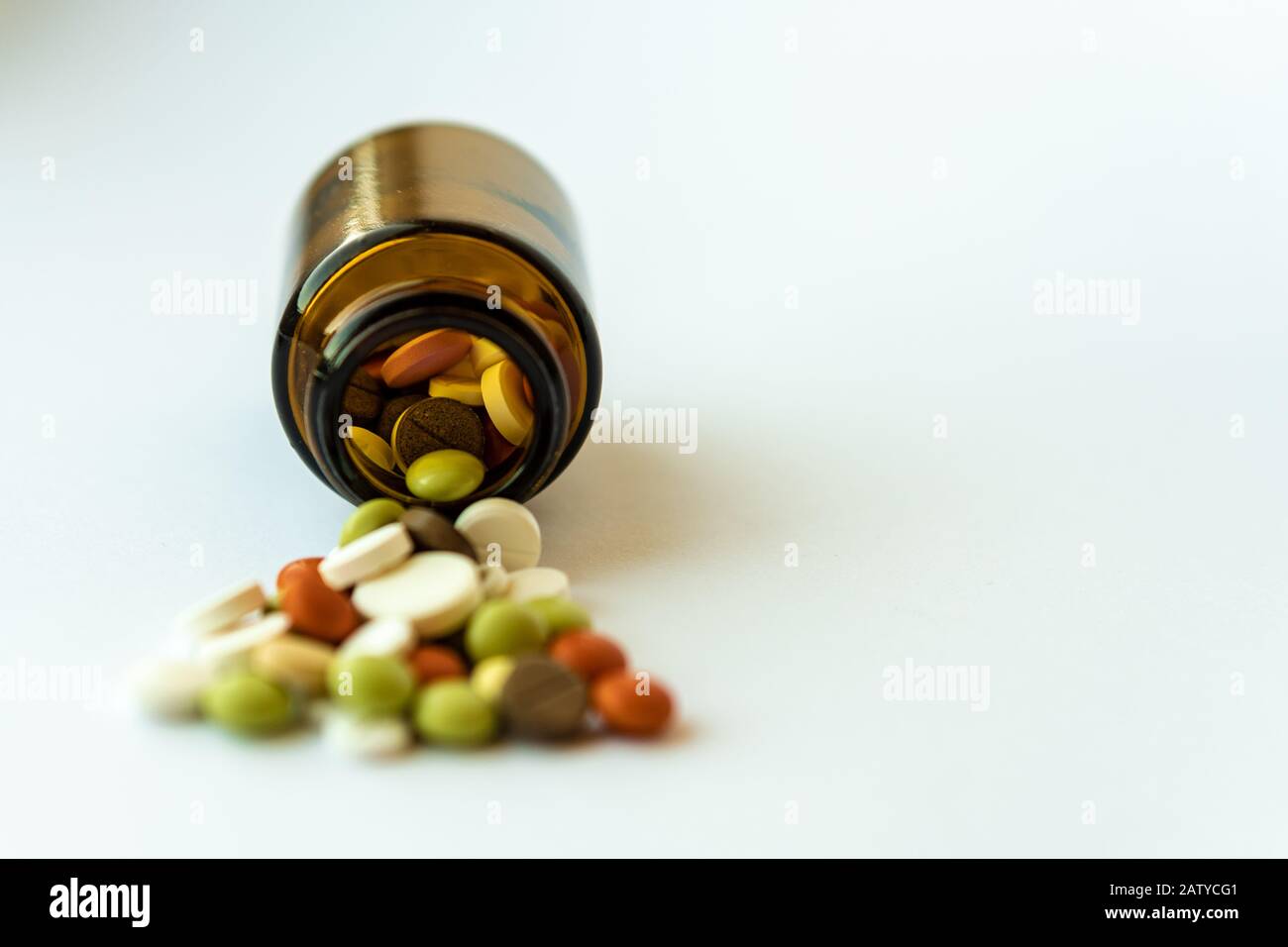 Medicine and pills. Multi-colored medicines on a white background close ...