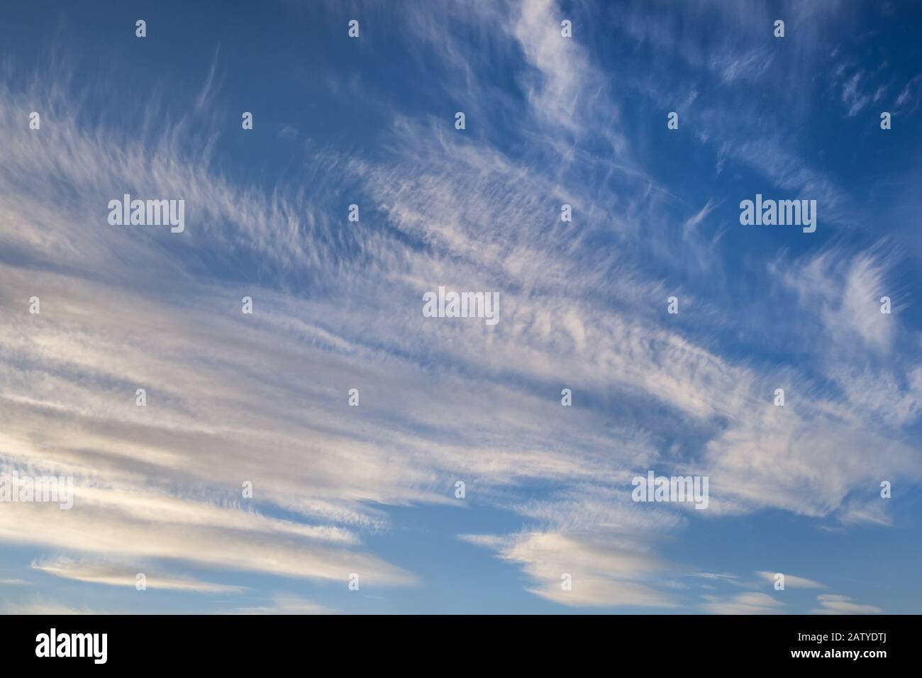 Blue sky background with tiny stratus cirrus striped clouds. Clearing ...