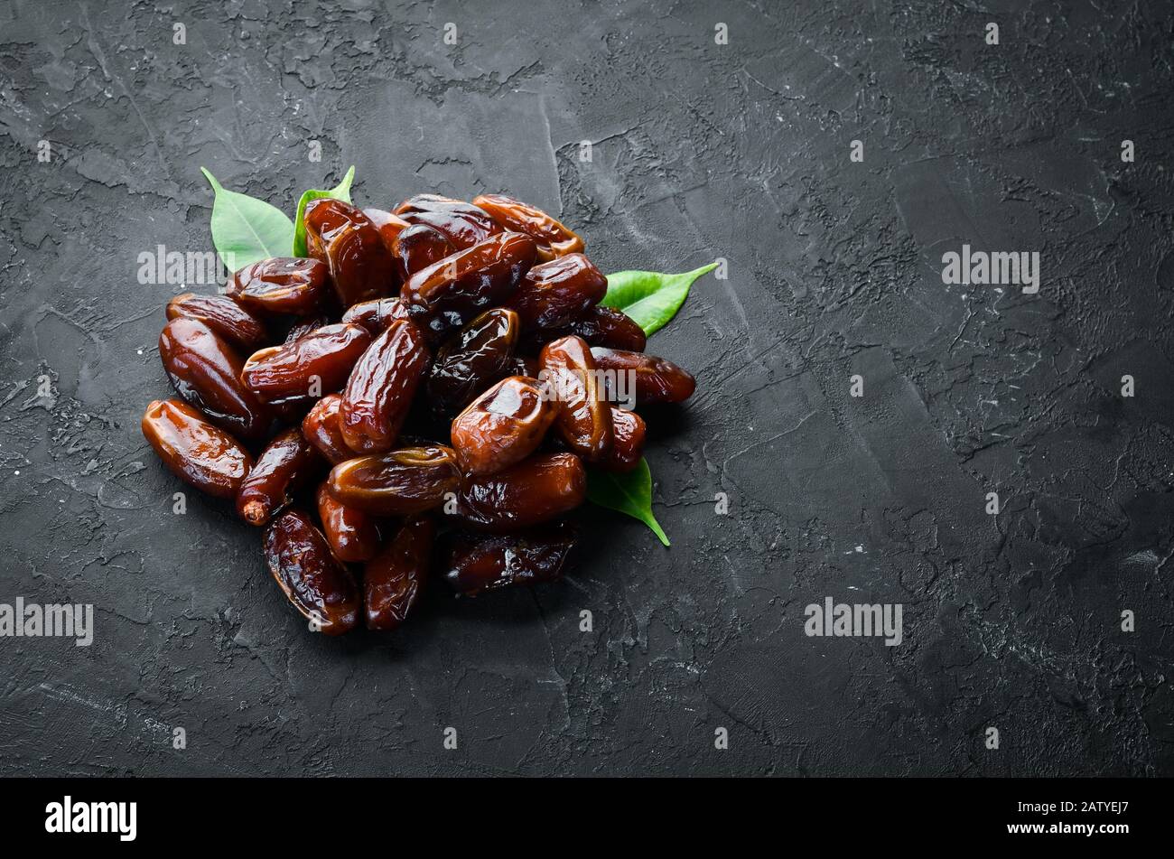 Dry date on a black background. Top view. Free space for your text ...
