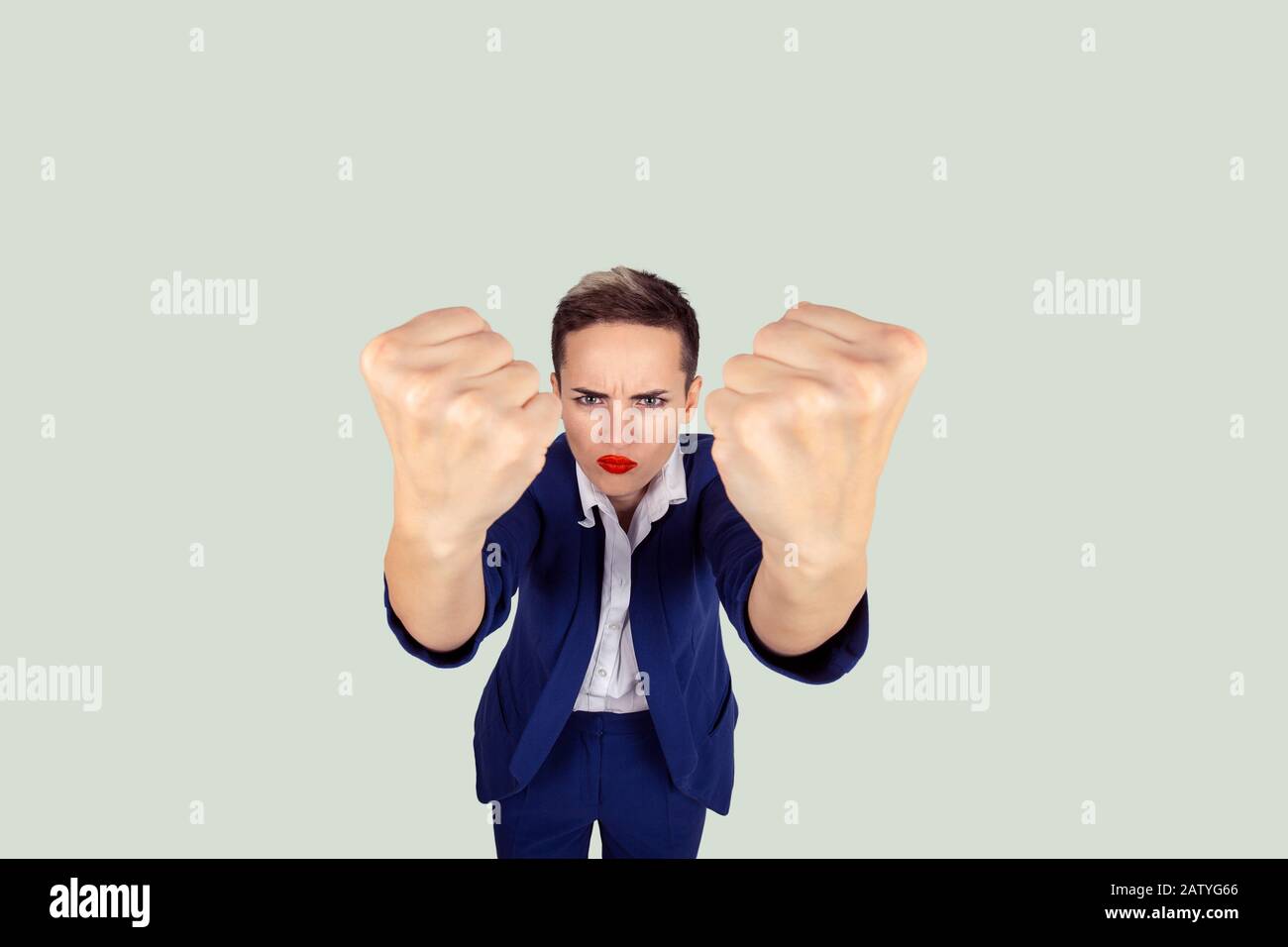 close up angry young woman showing fists about to punch hit someone to ...