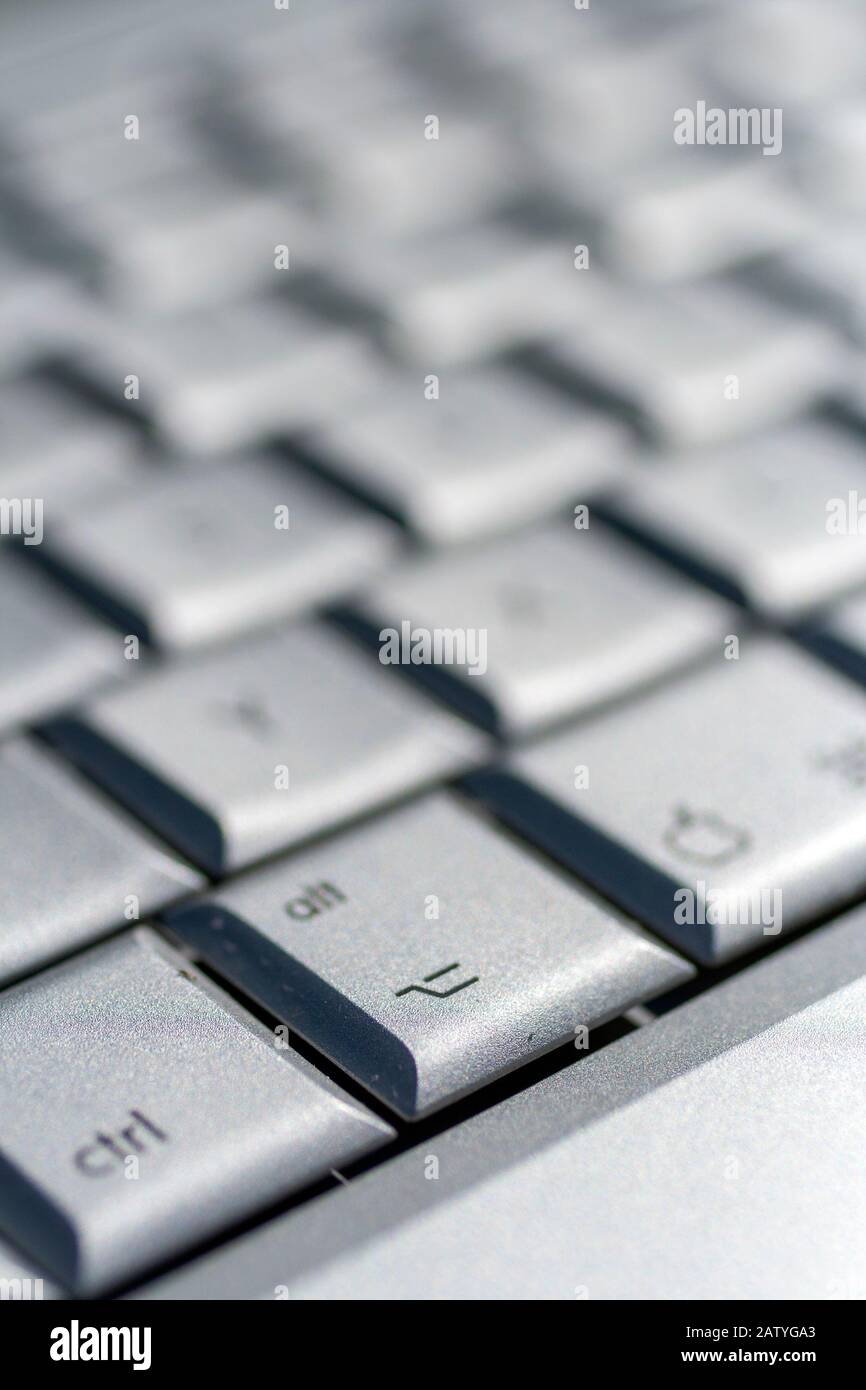 Silver keyboard on an old laptop Stock Photo - Alamy