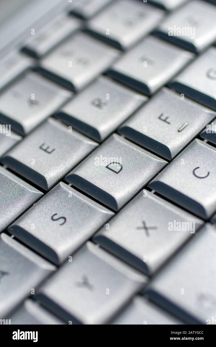 Silver keyboard on an old laptop Stock Photo - Alamy