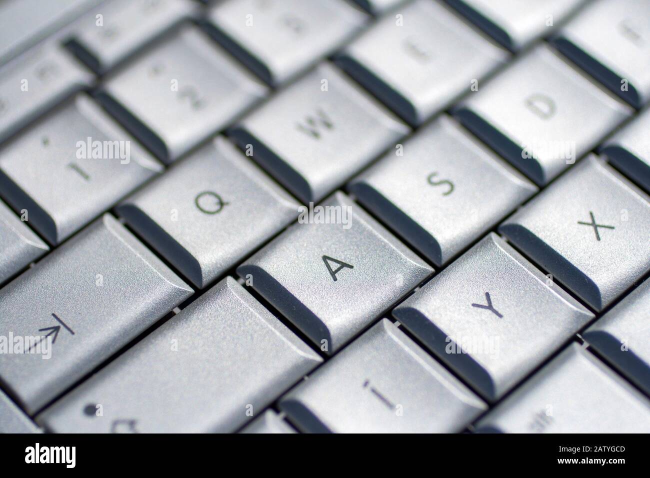Silver keyboard on an old laptop Stock Photo - Alamy