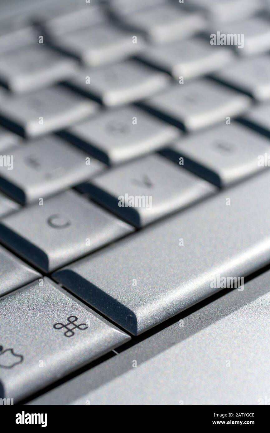 Silver keyboard on an old laptop Stock Photo - Alamy
