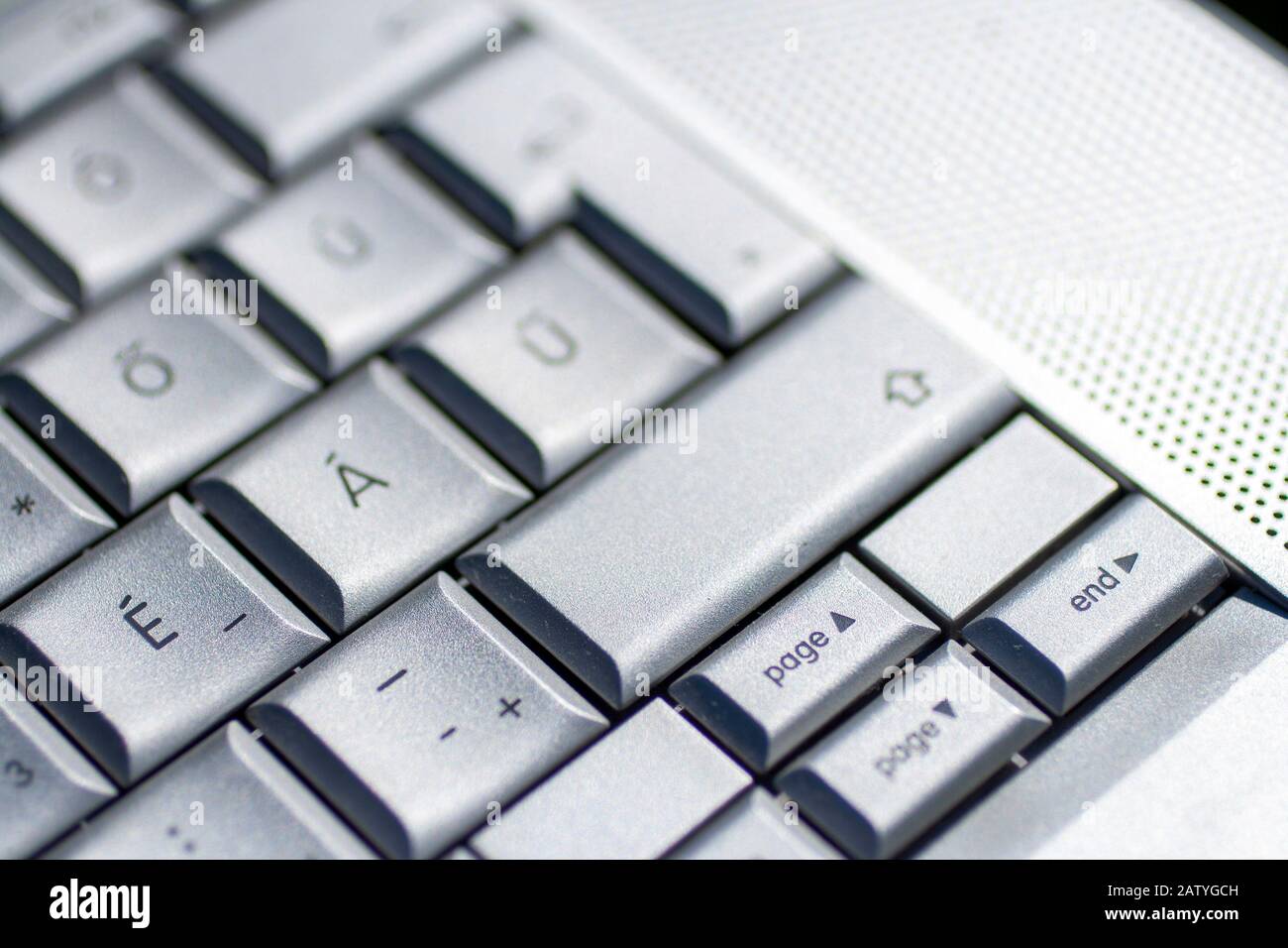 Silver keyboard on an old laptop Stock Photo - Alamy