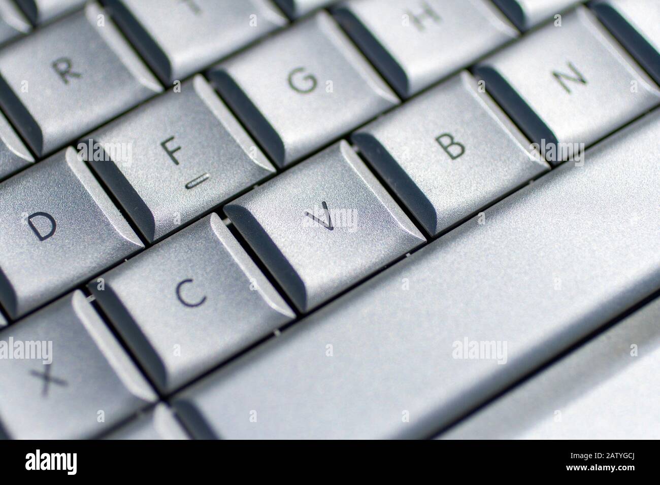 Silver keyboard on an old laptop Stock Photo - Alamy