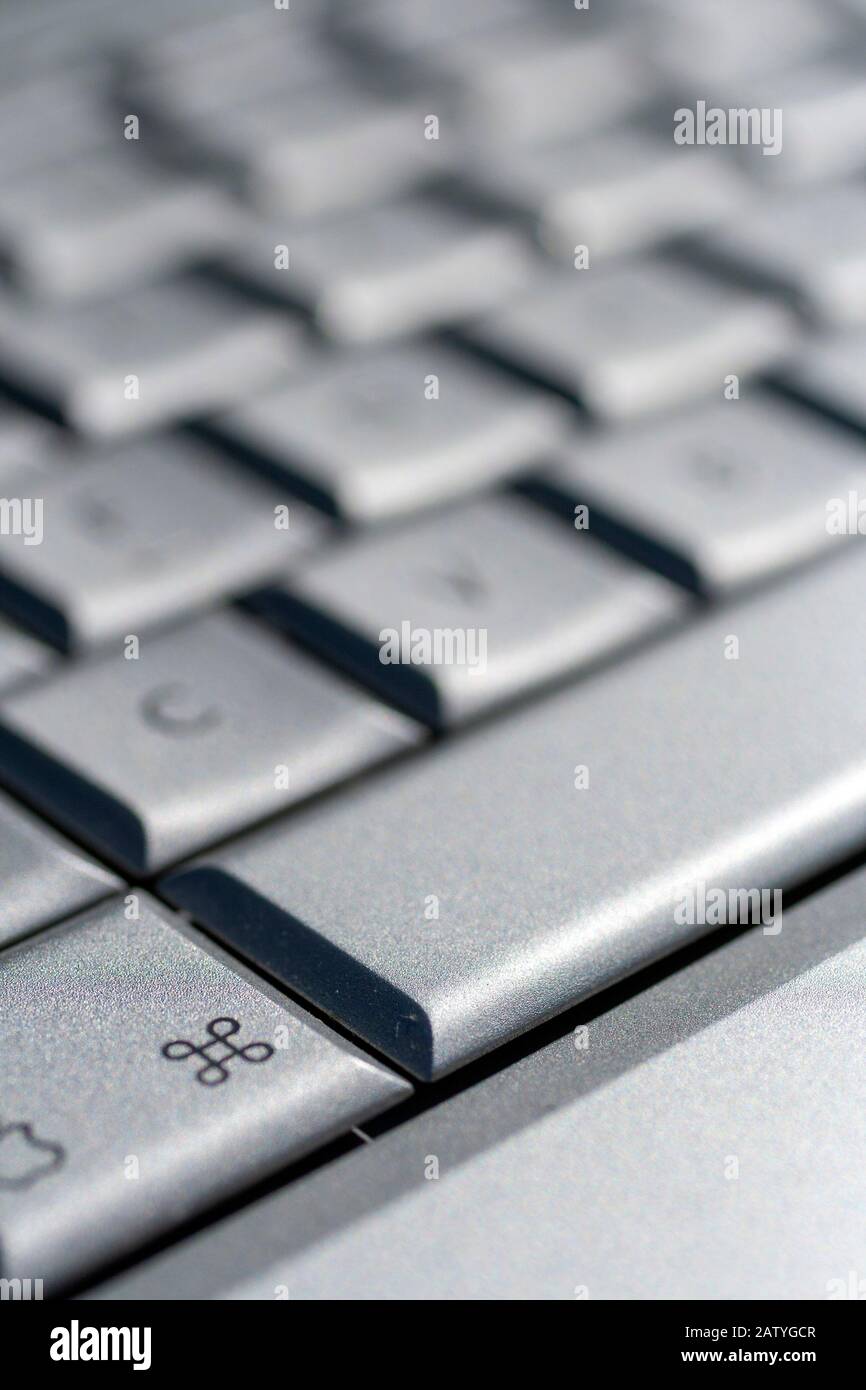 Silver keyboard on an old laptop Stock Photo - Alamy