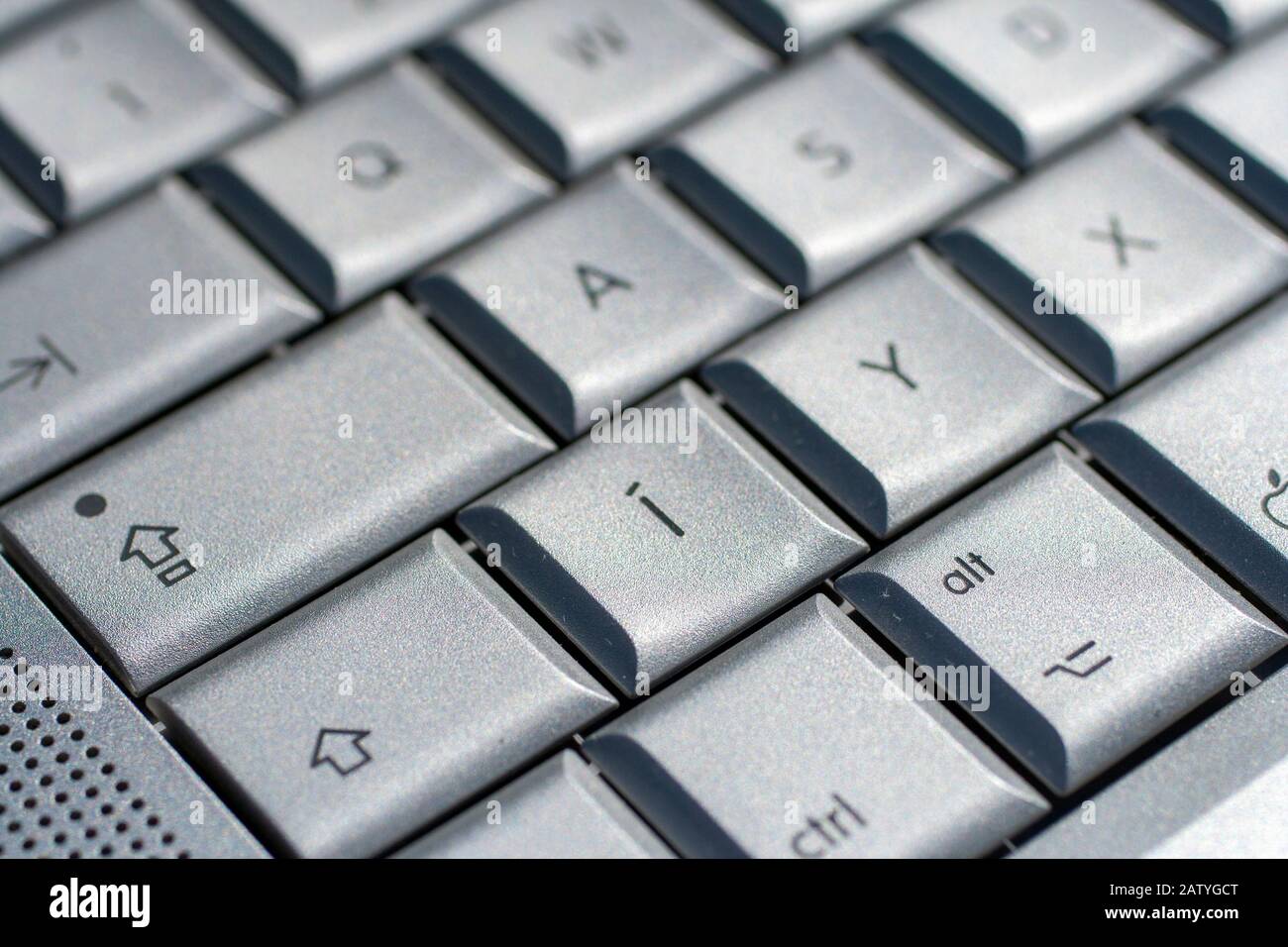 Silver keyboard on an old laptop Stock Photo - Alamy