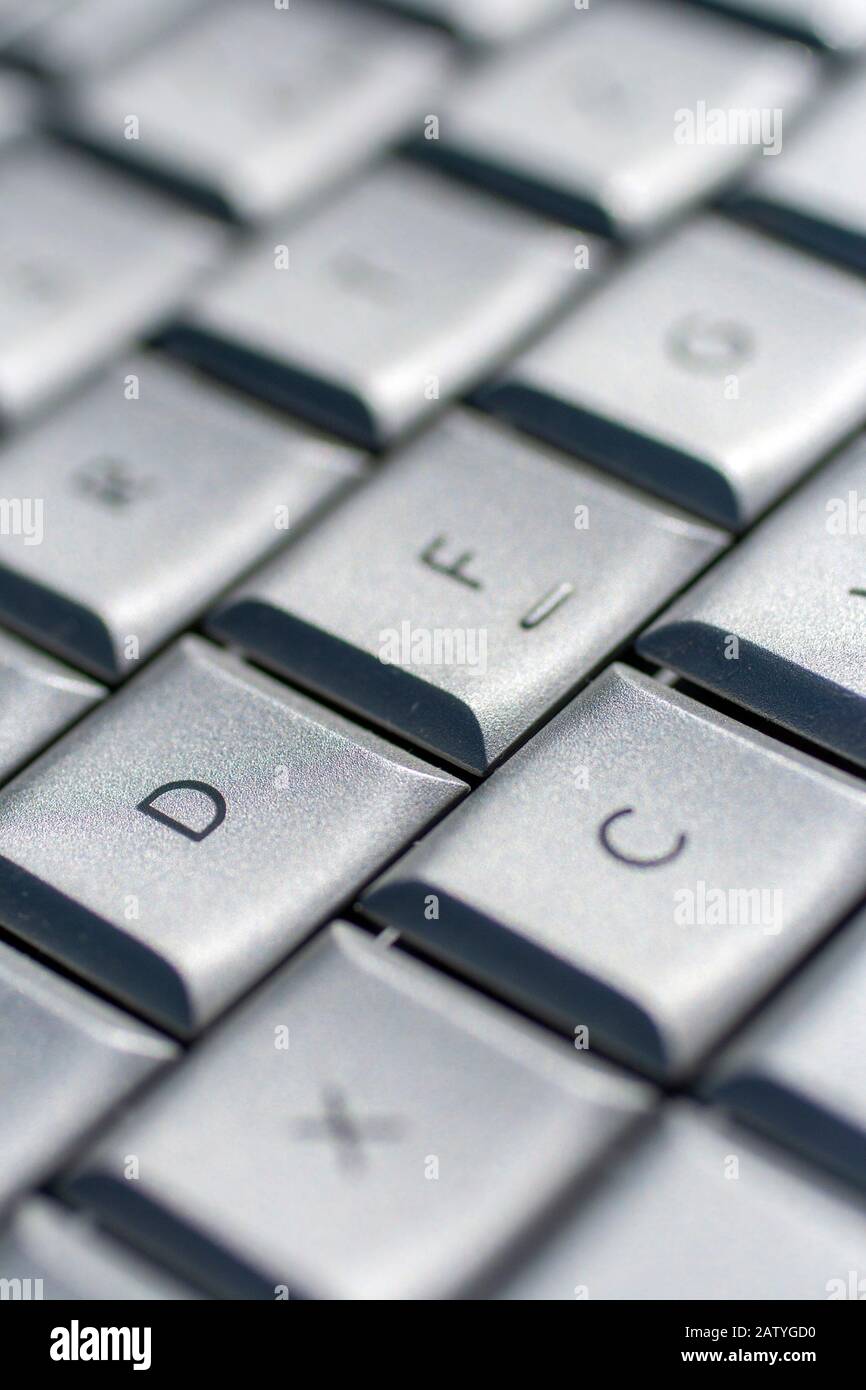Silver keyboard on an old laptop Stock Photo - Alamy