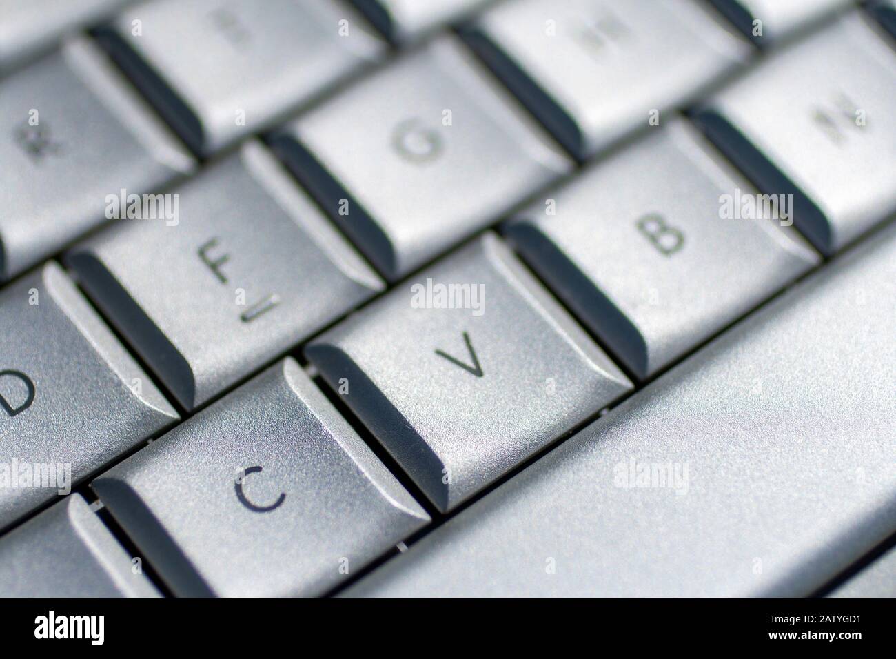 Silver keyboard on an old laptop Stock Photo - Alamy