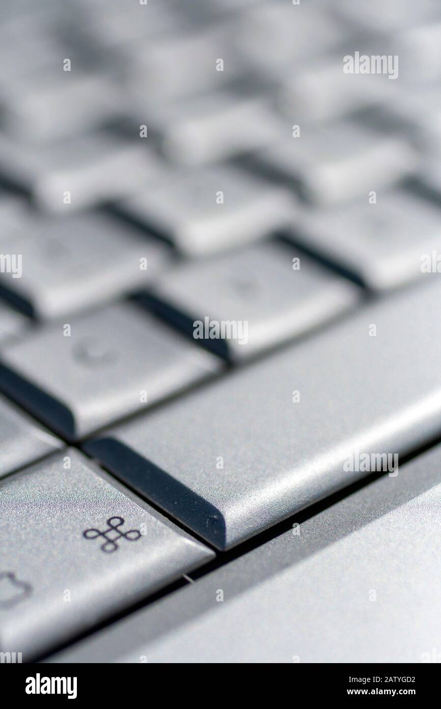 Silver keyboard on an old laptop Stock Photo - Alamy