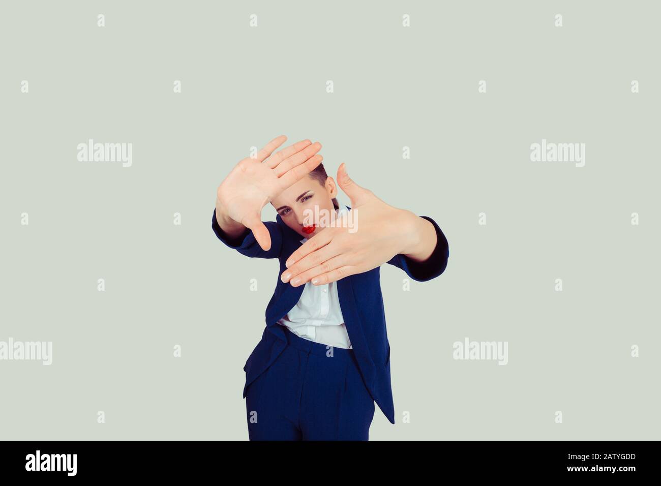 Woman making a frame with her huge big hands looking through it ...