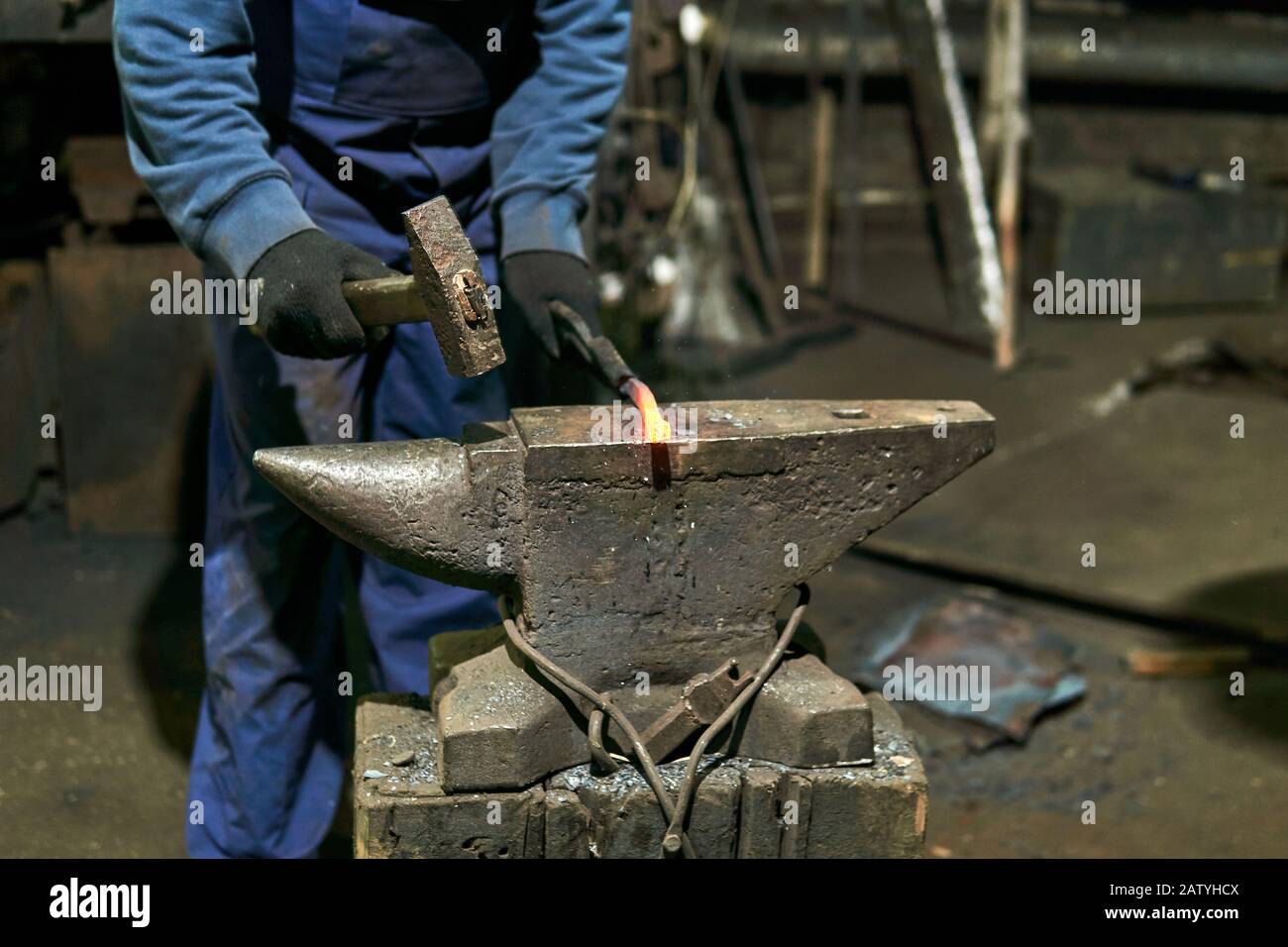 traditional forging of a hot metal billet on the anvil Stock Photo - Alamy