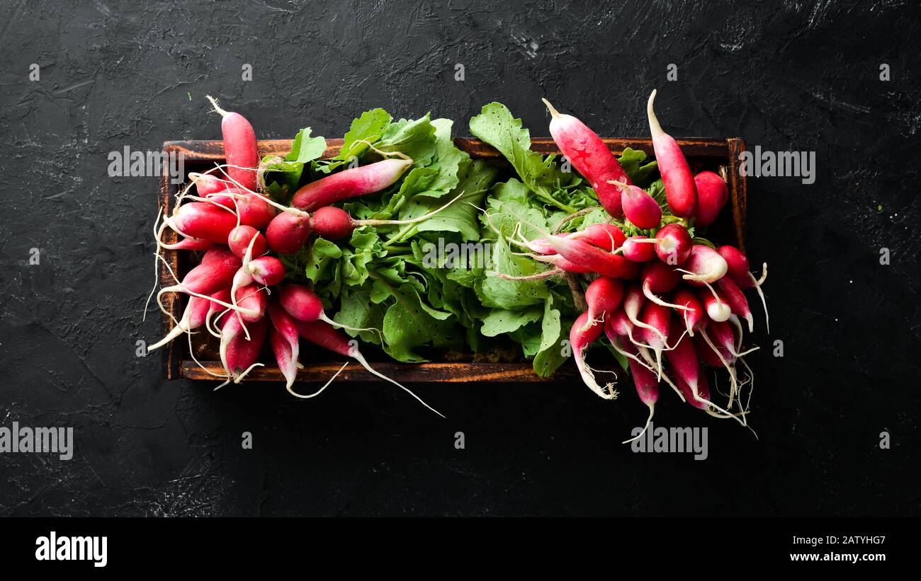 Fresh radish on a black stone background. Red radish Top view Stock ...
