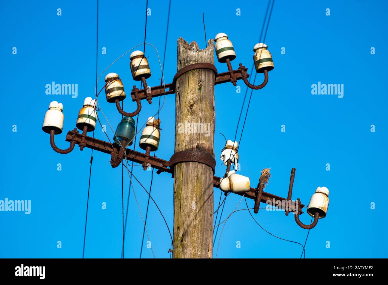 Old braided telephone wires on a wooden pole. Telecommunications ...