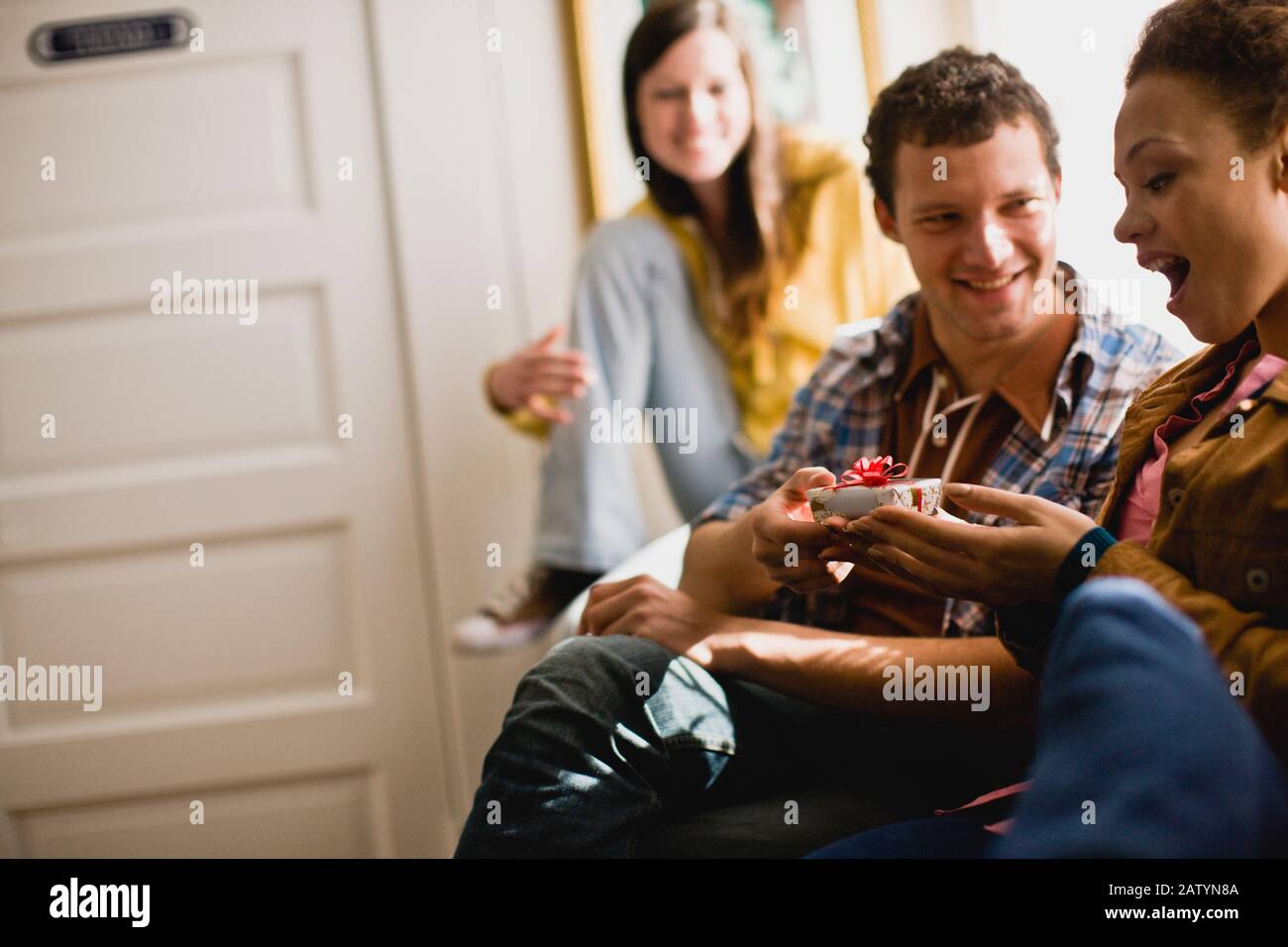 Woman receiving gift from friend hi-res stock photography and images ...
