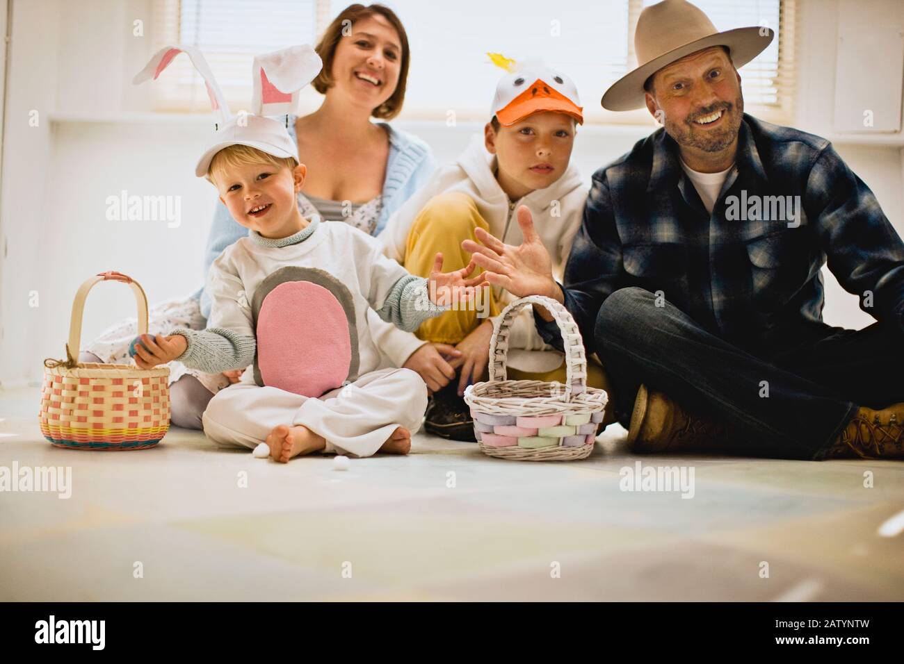 Two boys dressed up for Easter with their parents Stock Photo - Alamy