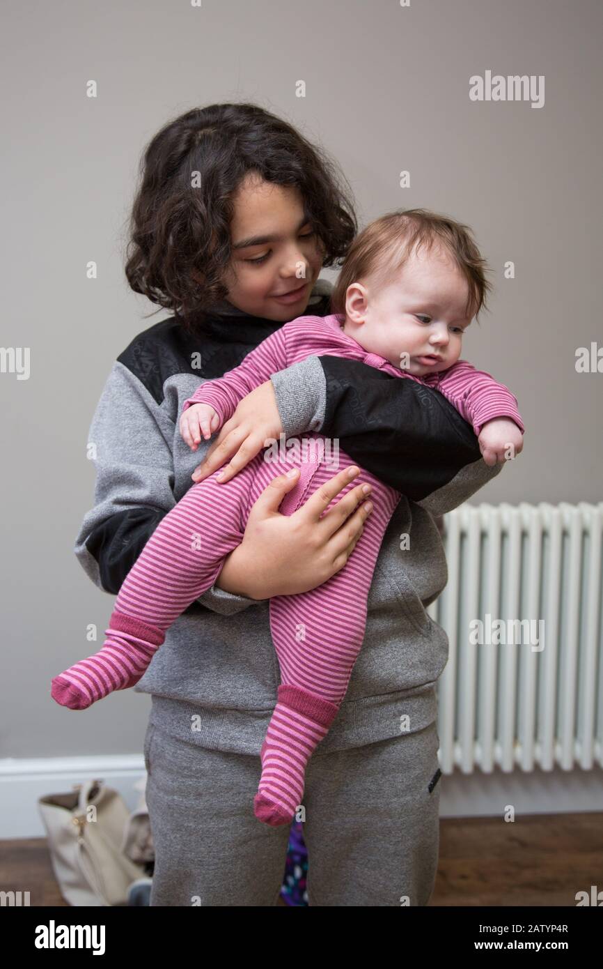 Teenage boy babysitting, UK Stock Photo - Alamy
