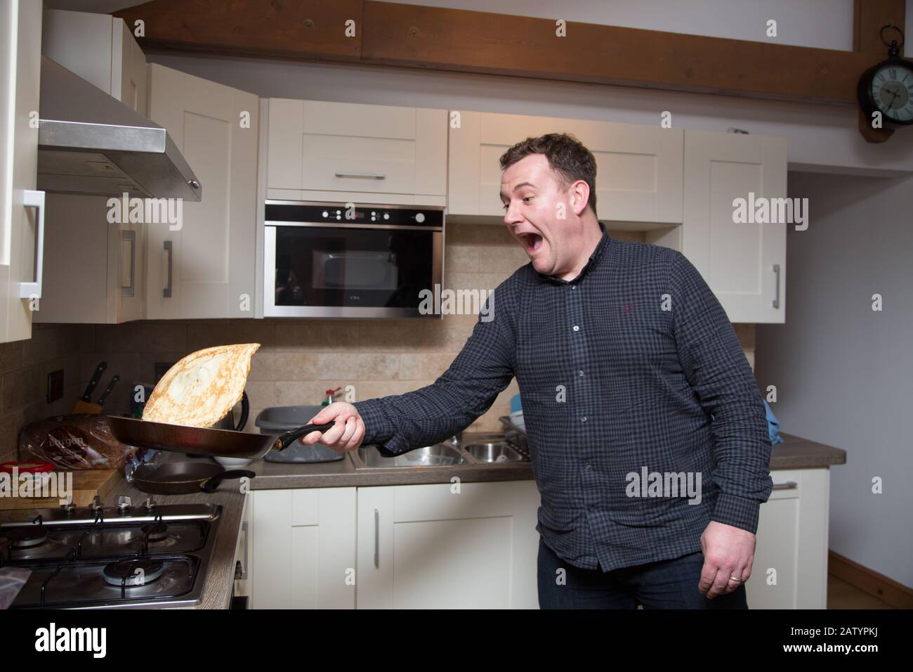 A man tossing a pancake, UK Stock Photo - Alamy