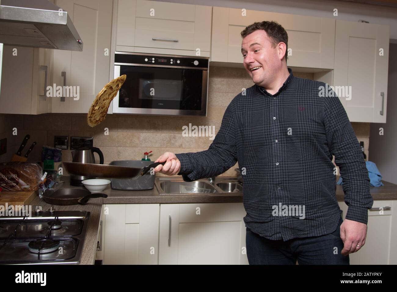 A man tossing a pancake, UK Stock Photo - Alamy