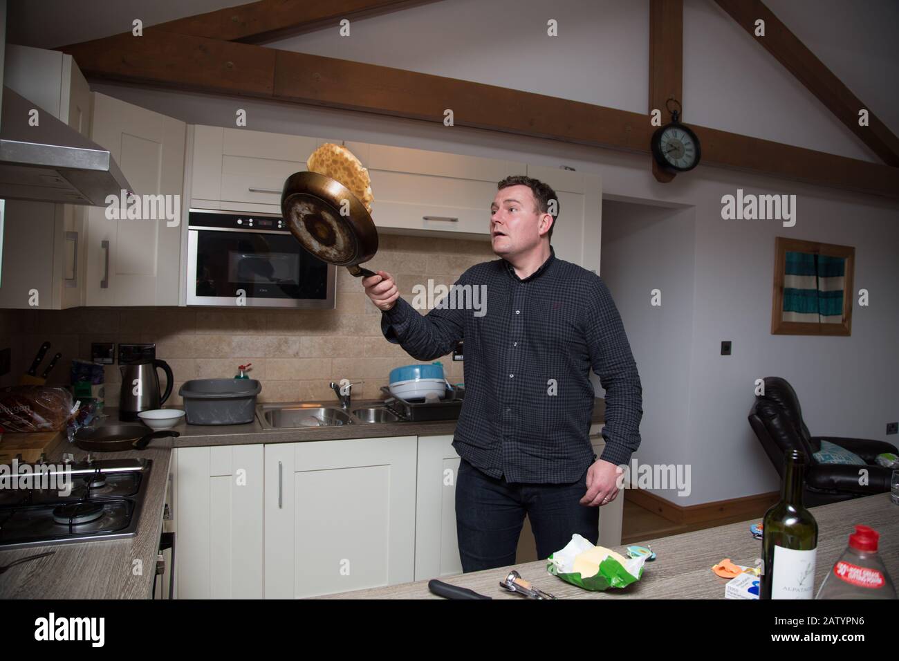 A man tossing a pancake, UK Stock Photo - Alamy