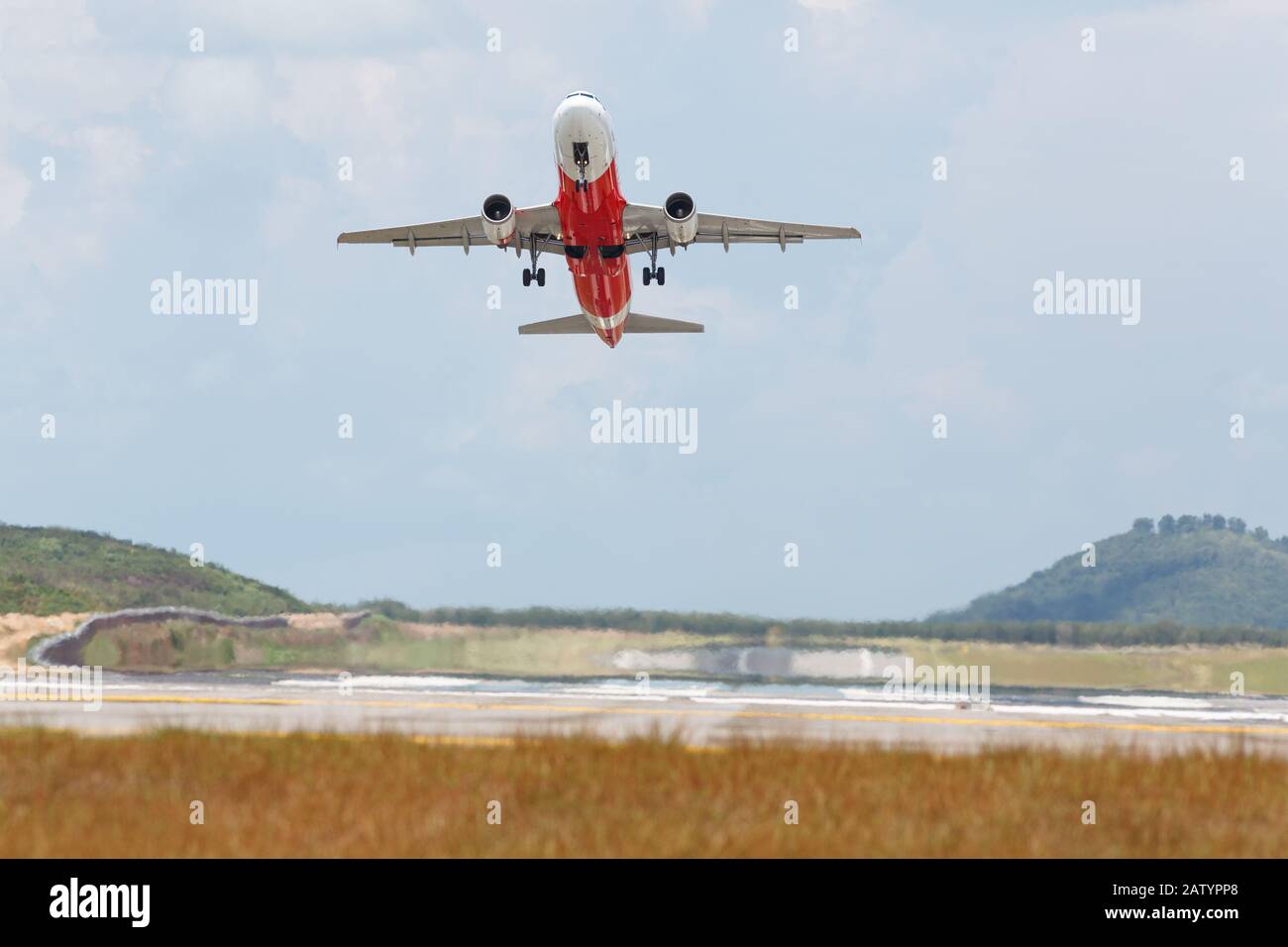 Airplane taking off in summer day front view. Plane fly up, low over ...
