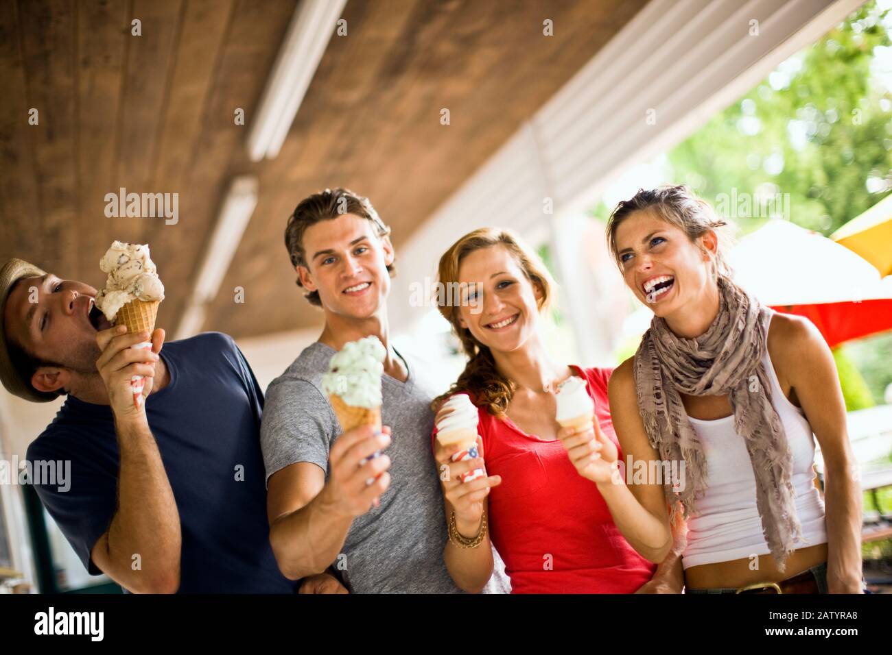 Friends eating giant ice creams Stock Photo - Alamy