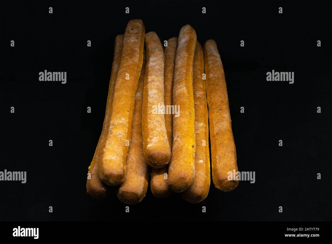 Breadsticks isolated on a black background Stock Photo - Alamy