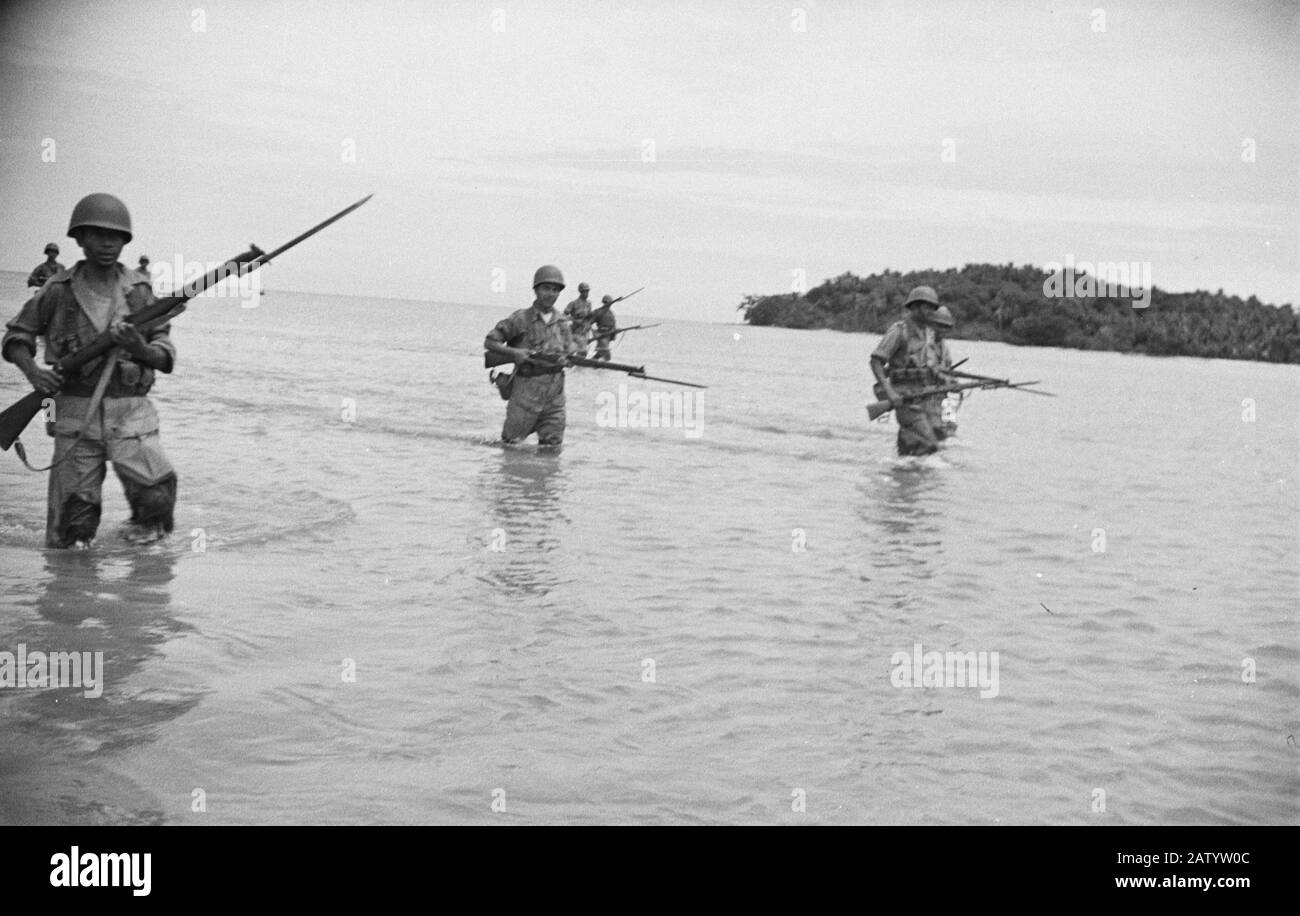 Borneo Soldiers wade through the sea to the beach Date: February 1947 ...