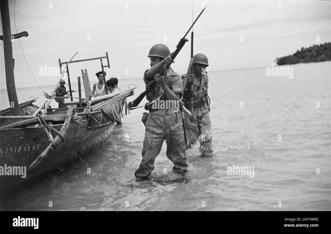 Borneo Soldiers wade through the sea to the beach Date: February 1947 ...