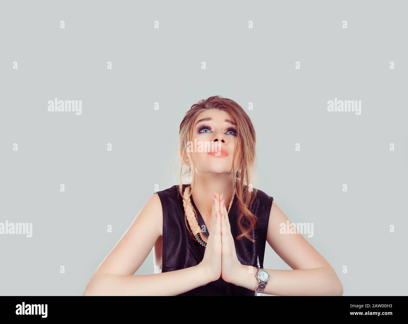 Young woman praying looking up with hope isolated gray background Stock ...