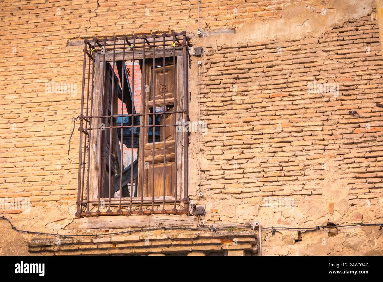 window protect from rusty metal bar on the brick wall of a ruined ...