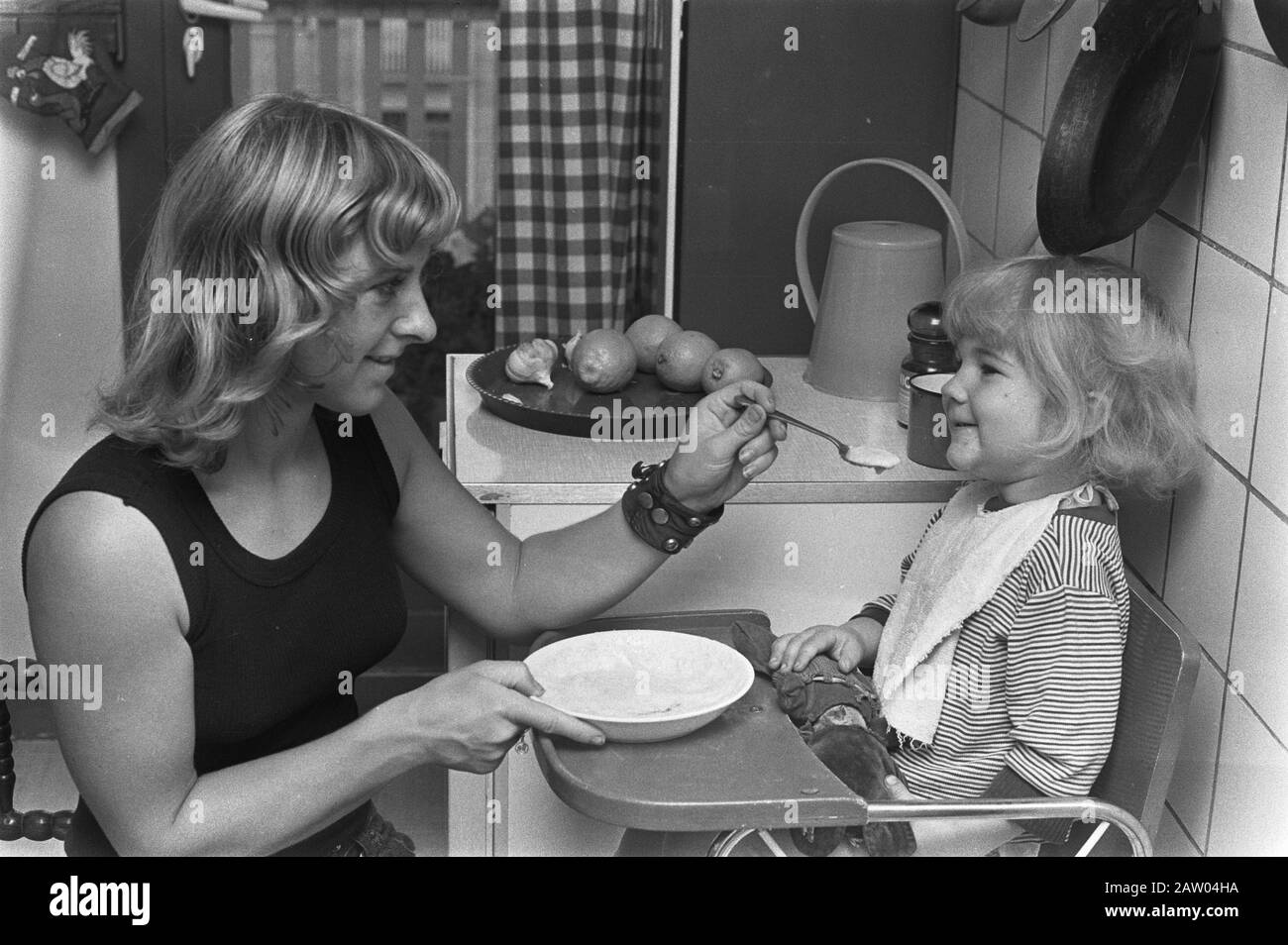 Mother child care; give food Date: July 30, 1970 Stock Photo - Alamy