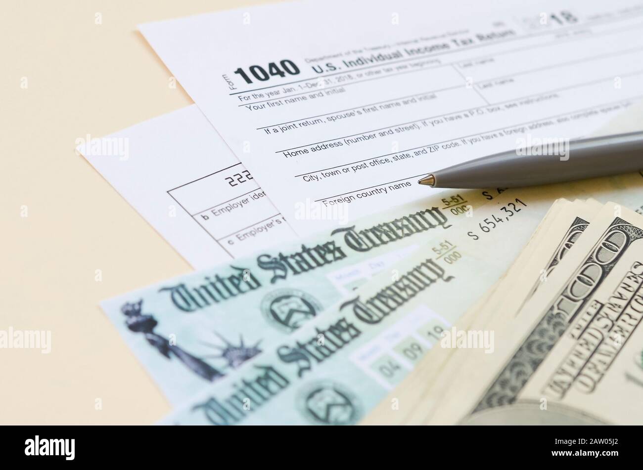 1040 Individual Income tax return form with Refund Check and hundred ...