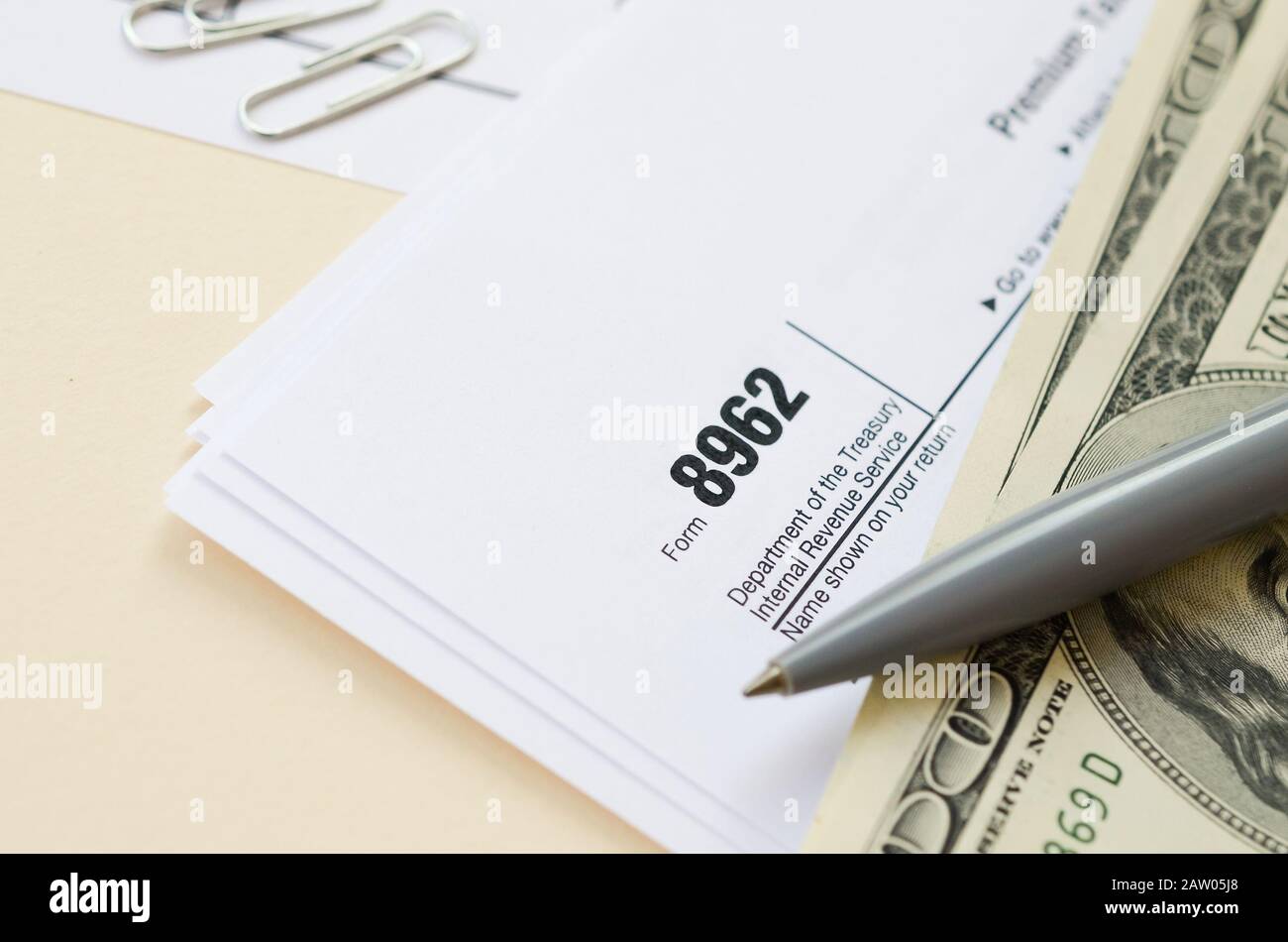 IRS Form 8962 Premium tax cerdit PTC blank lies with pen and many ...