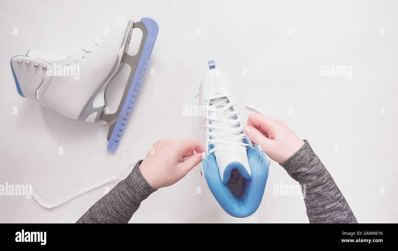 Flat lay. Lacing new white figure skates with white laces Stock Photo ...