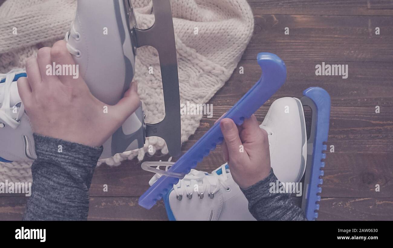 Flat lay. Putting on blue blade guards on white figure skates Stock ...